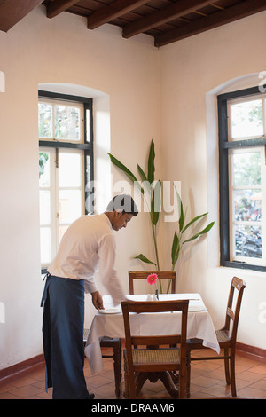Waiter laying table Stock Photo - Alamy