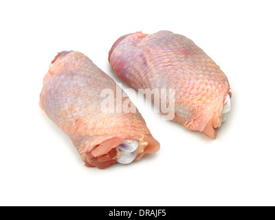 Two fresh raw chicken thighs with skin on a wooden board. Rustic ...