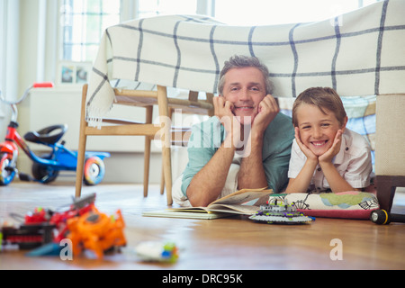 Father and son together enjoying reading and discussing school homework ...