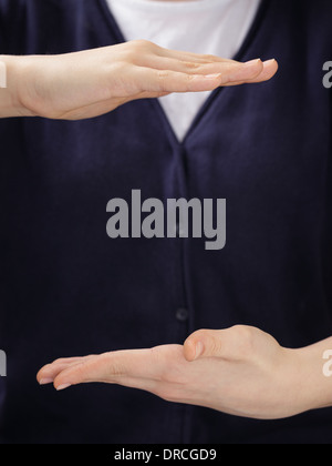 Young female pleading, holding hands in prayer on blue background ...