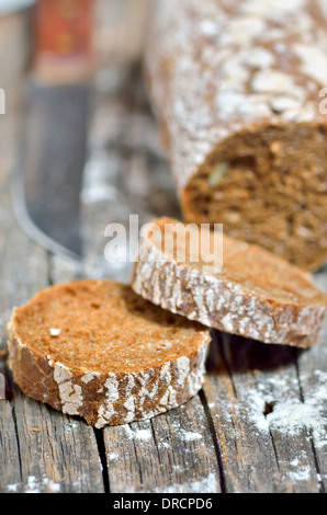 Sliced loaf of fresh rye bread on black table Stock Photo - Alamy