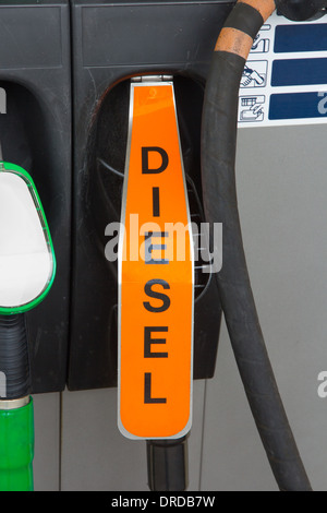 Metal fuel nozzle, filling gas tank of car covered with snow in winter ...