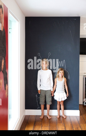 Kids writing on chalkboard wall Stock Photo - Alamy