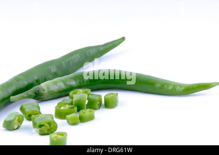 whole and chopped chillies on white background. horizontal studio shot ...