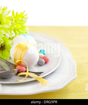 Easter table setting with eggs, ribbon and cutlery,wooden background ...
