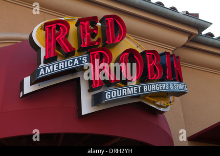 A logo sign outside of a Red Robin Gourmet Burgers and Brews restaurant ...