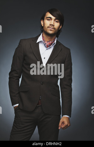 Young stylish handsome man posing in modern city park, wearing suit and ...