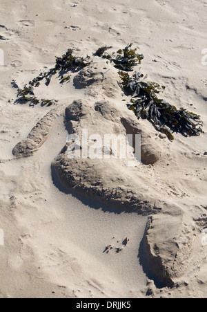 Sculpture of a mermaid with sand on the beach Stock Photo - Alamy