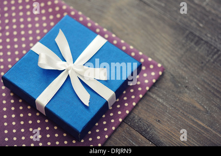 white ribbon on the wooden background with copy space. White or light ...