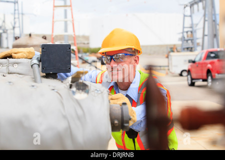 Electrical engineer examining pressure sensor at an electric power ...