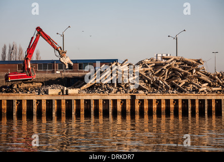 excavator crushing concrete piles Stock Photo - Alamy