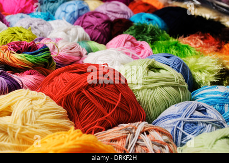 Different color threads on rows in the store Stock Photo - Alamy