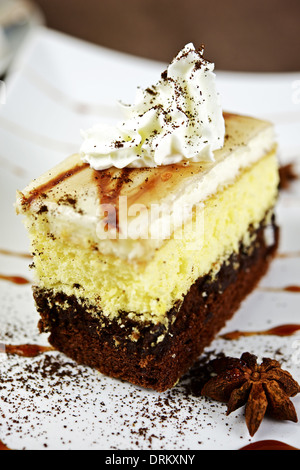 Slice of cake with cream on top Stock Photo - Alamy