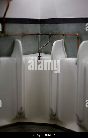 Man in a toilet with urinals Stock Photo - Alamy