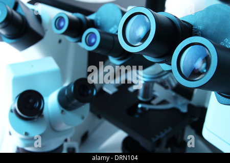 Many laboratory microscopes in blue light Stock Photo - Alamy