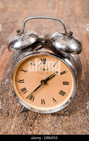 black vintage alarm clock on the black background Stock Photo - Alamy