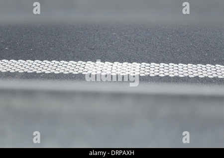 White Rumble Strip on the Road thru Crash Barriers Stock Photo - Alamy