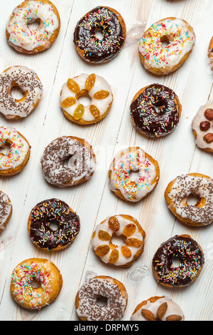 A close-up shot of donuts with different frostings on an event table ...