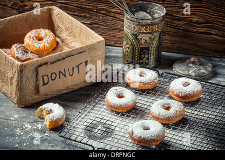 Tasting freshly baked donuts Stock Photo - Alamy