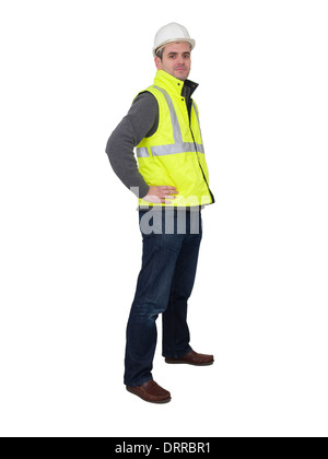 latin worker with yellow hard hat, glasses and green vest, with a diary ...