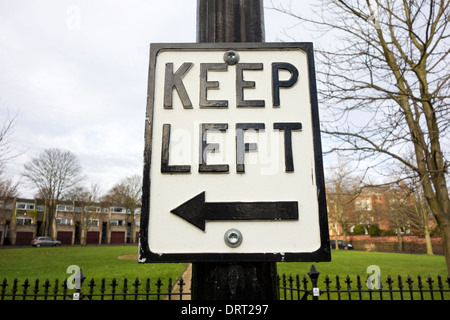 Keep Left road sign arrow at a traffic island in England Stock Photo ...