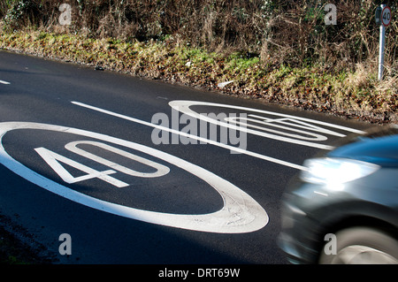 car driving past 40mph speed limit painted on on single carriage ...