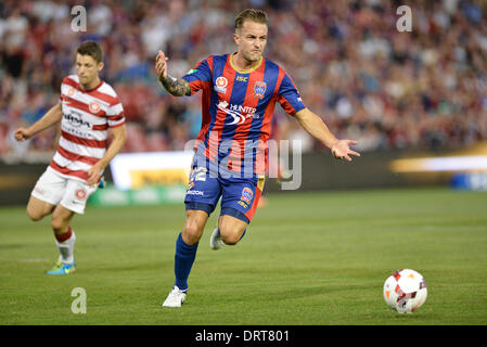Adam Taggart of Newcastle Jets FC is chased by Ivan Franjic of Brisbane ...