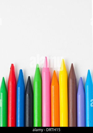 Vertical shot of colorful crayons on a yellow surface Stock Photo - Alamy