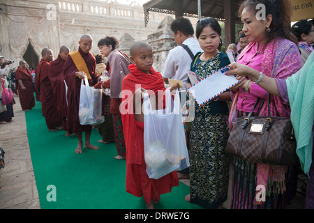 Monks receiving alms during The Ananda Festival Bagan, Myanmar (Burma ...