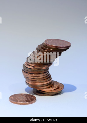 Toppling stacks of copper coins Stock Photo - Alamy