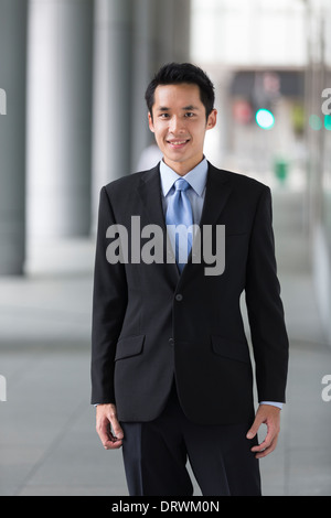 Chinese business man in modern Asian city. Portrait of an Asian ...