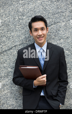 Chinese business man in modern Asian city Stock Photo - Alamy