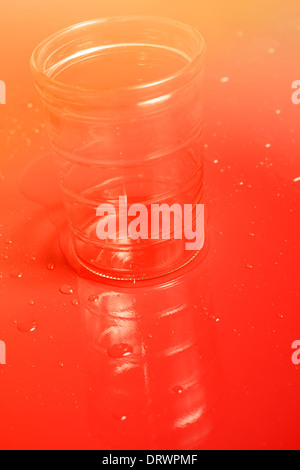 Empty glass on orange background Stock Photo - Alamy