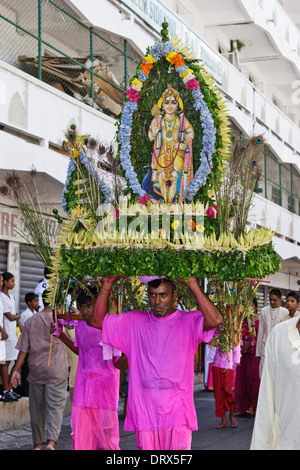 A Tamil devotee of Lord Muruga carrying the Cavadee with his cheeks and ...