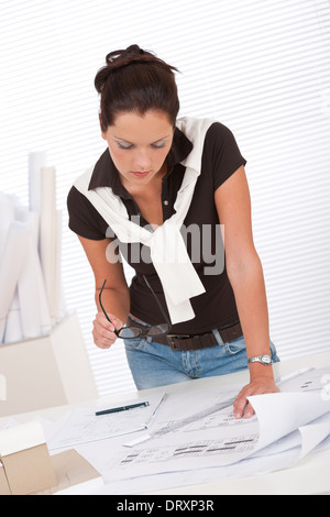 Young architect reading plan Stock Photo - Alamy