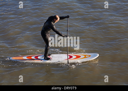 paddle boarder at Bournemouth in January Stock Photo - Alamy