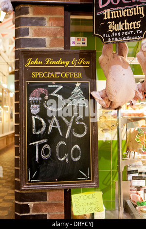 Dead game birds hanging on a butchers sign at Christmas Stock Photo - Alamy