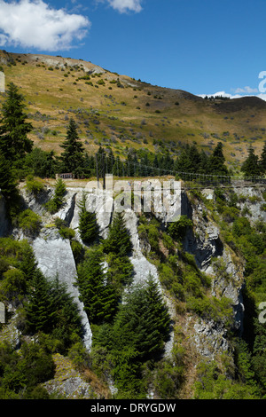 Mountain bikers above the Arrow River on Edgar suspension bridge, Arrow ...