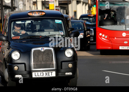 Red London buses & black cab (taxi) wooden toys on white background ...