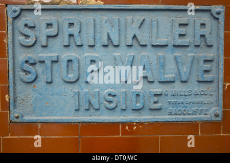 Sprinkler stop valve inside, old cast iron sign Stock Photo - Alamy