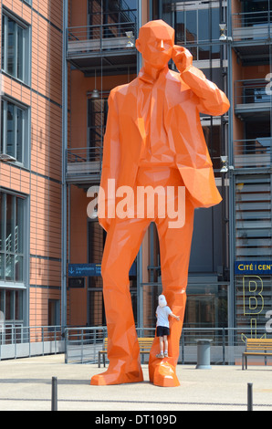 Giant orange statue of man on mobile phone, L'amphitheatre, cité ...