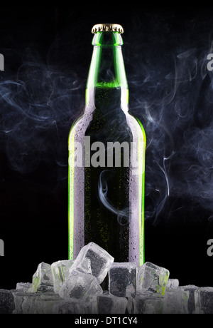 Cold beer bottle with chill smoke on black background Stock Photo - Alamy