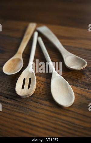 Wood spoons. Four small wood spoons on kitchen table Stock Photo - Alamy