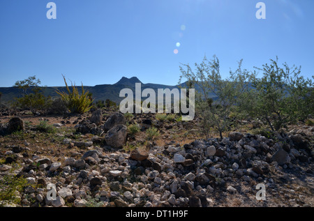 Rocks and scrub land in the foothills around 'the Witch's Teat' rock ...