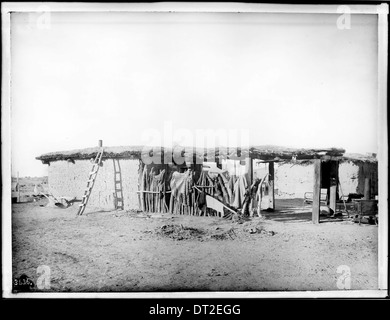 This photograph shows Native Pima Indian summer dwellings, called 'Kans ...