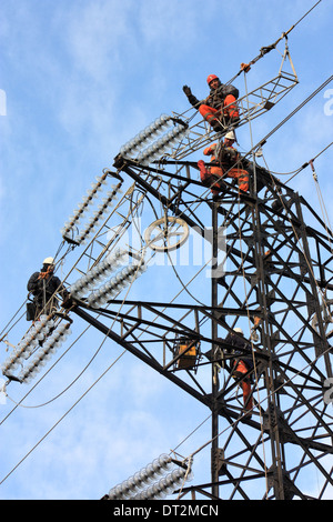 Workers at electricity pylons in Italy. Maintenance work of a high ...