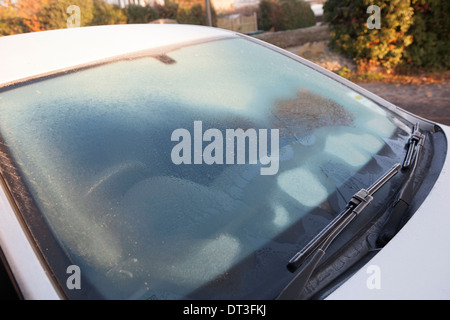 Frozen car windscreen defrosting, ice is melting Stock Photo - Alamy
