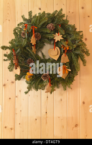 Beautiful Christmas wreath decorated with sweets and berries on green ...