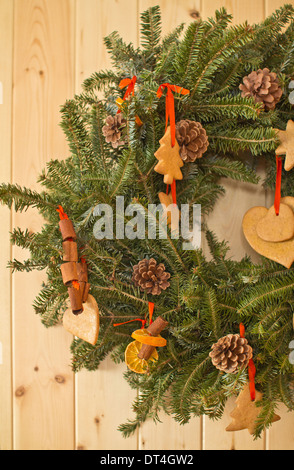 Beautiful Christmas wreath decorated with sweets and berries on green ...