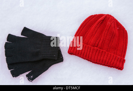 Red wool hat and black gloves with snow Stock Photo - Alamy